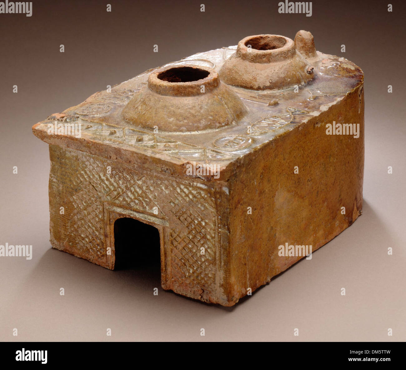 This funerary sculpture features a stove, an object associated with the ...