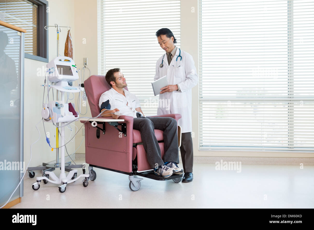 Doctor Showing Digital Tablet To Patient In Chemo Room Stock Photo - Alamy