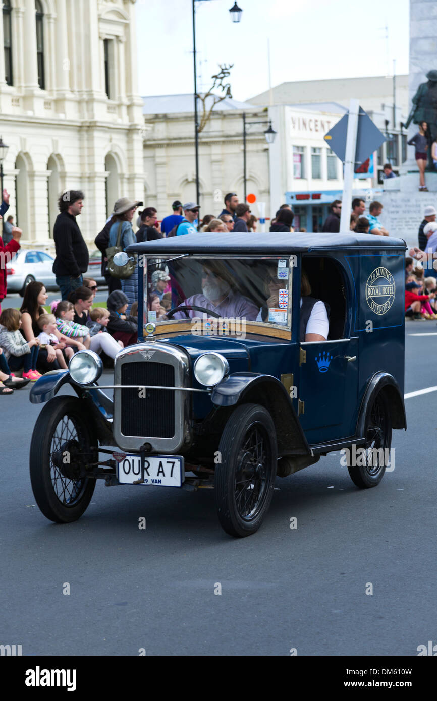 A beautifully restored Austin panel van drives down the main road of ...