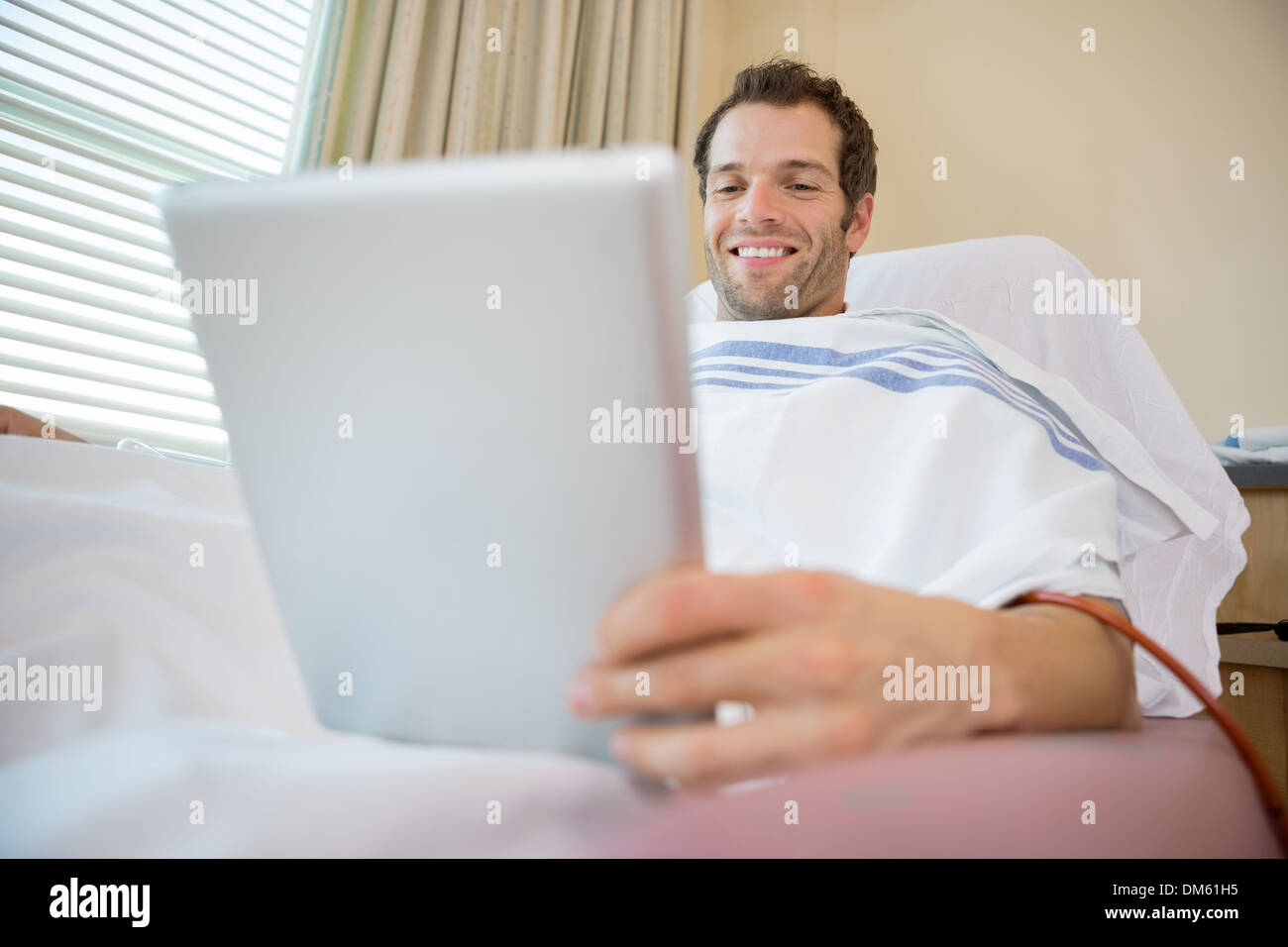 Patient Using Digital Tablet During Renal Dialysis Stock Photo - Alamy