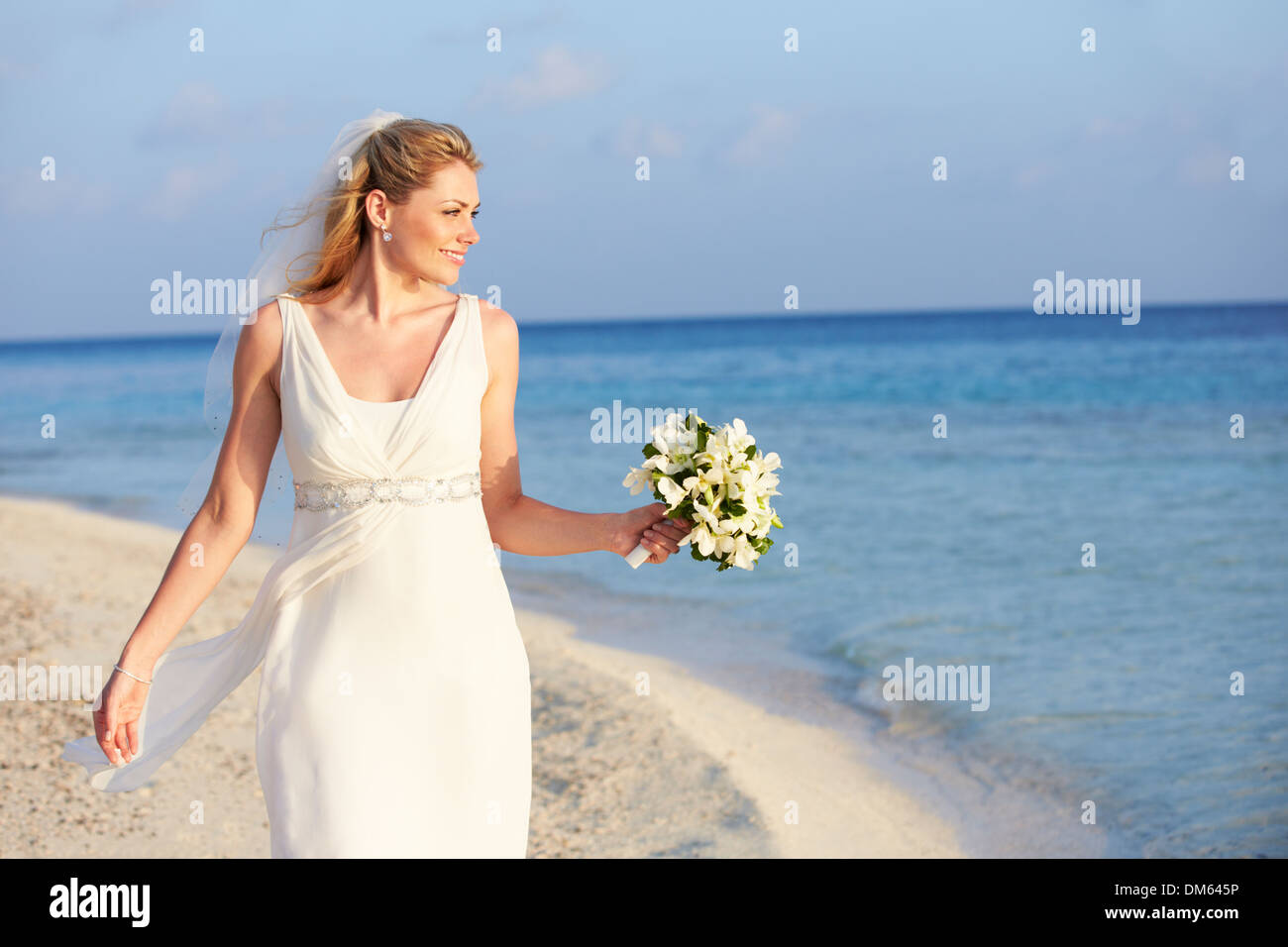Beautiful Bride Getting Married In Beach Ceremony Stock Photo - Alamy