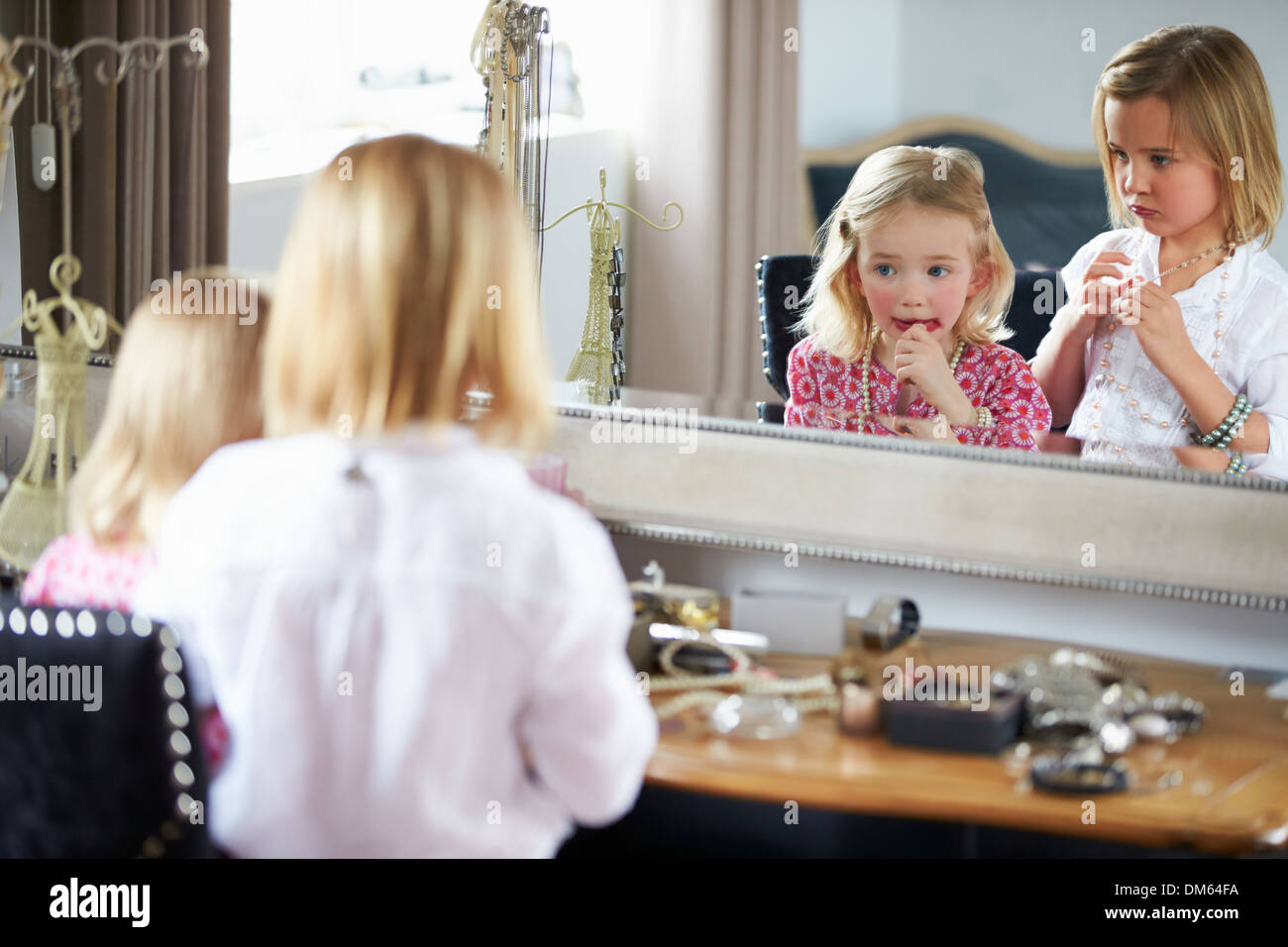 Two Girls Playing With Jewelry And Make Up Stock Photo - Alamy