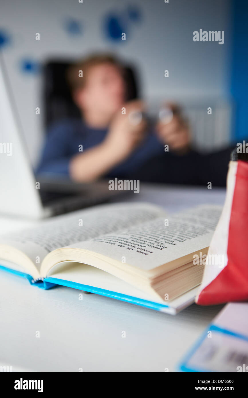 Teenage Boy Playing Video Game Instead Of Studying Stock Photo - Alamy Teenage Boy Playing Video Game Instead Of Studying Stock Photo - Alamy