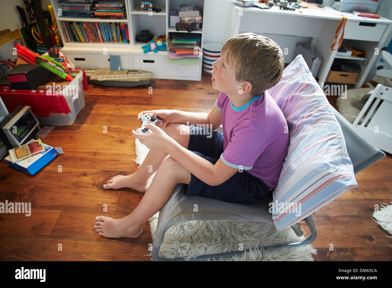 Boy Holding Controller Playing Video Game Stock Photo - Alamy