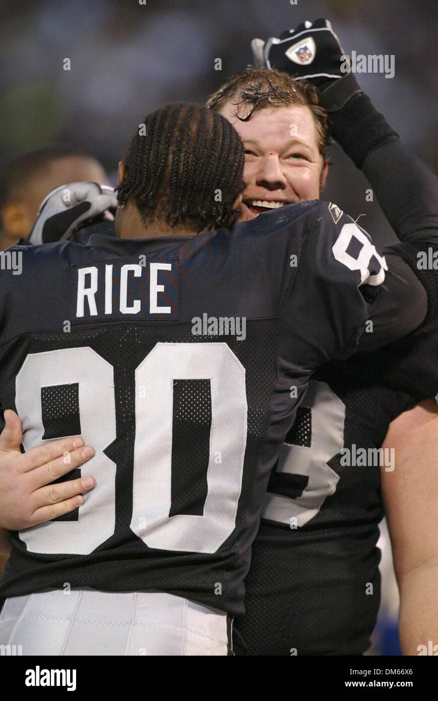 Center Barret Robbins hugs Jerry Rice toward the end of the game on the ...