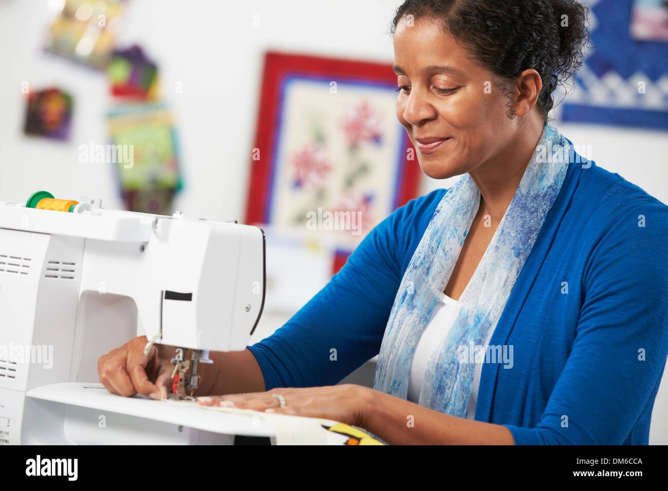 Woman Using Electric Sewing Machine Stock Photo - Alamy