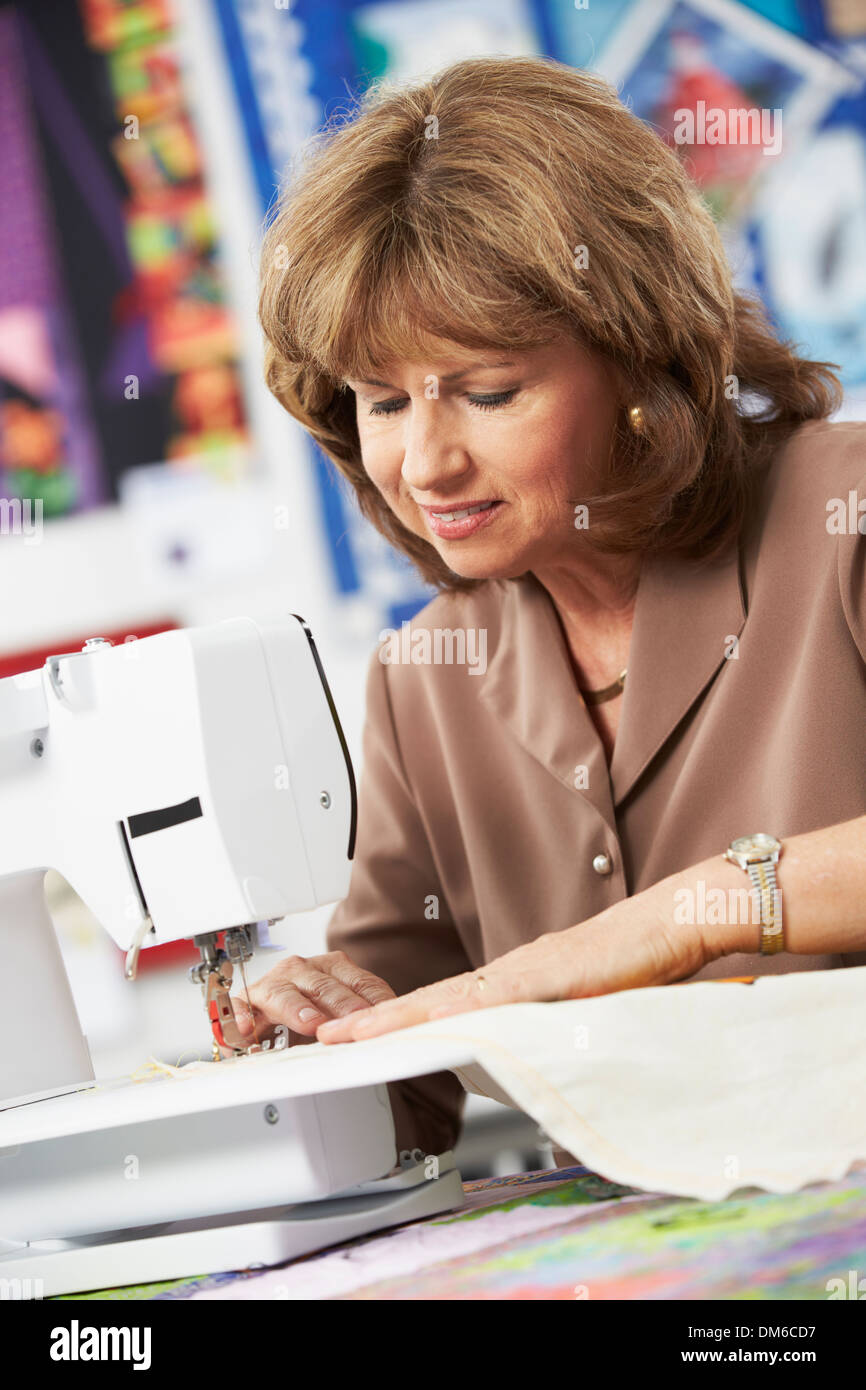 Woman Using Electric Sewing Machine Stock Photo - Alamy