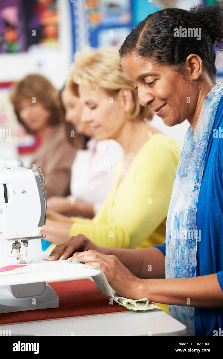 Group Of Women Using Electric Sewing Machines In class Stock Photo - Alamy