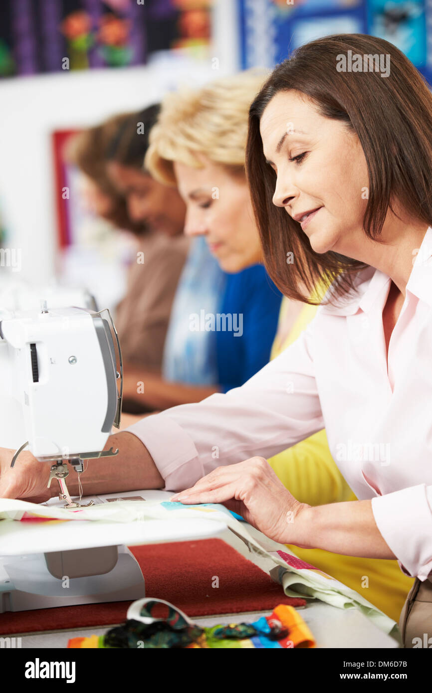 Group Of Women Using Electric Sewing Machines In class Stock Photo - Alamy