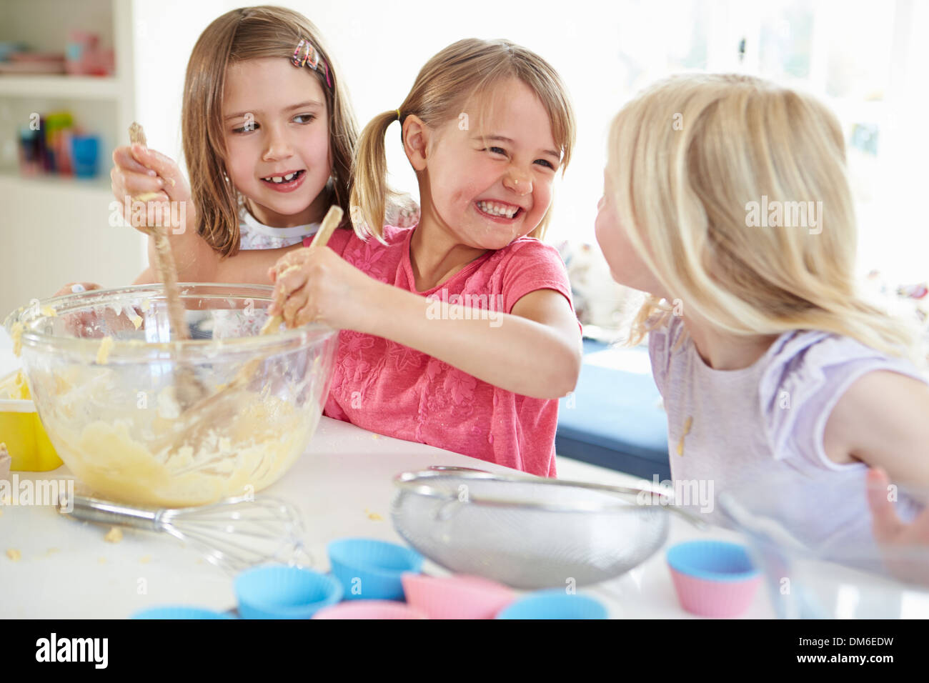 Three Girls Making Cupcakes In Kitchen Stock Photo - Alamy
