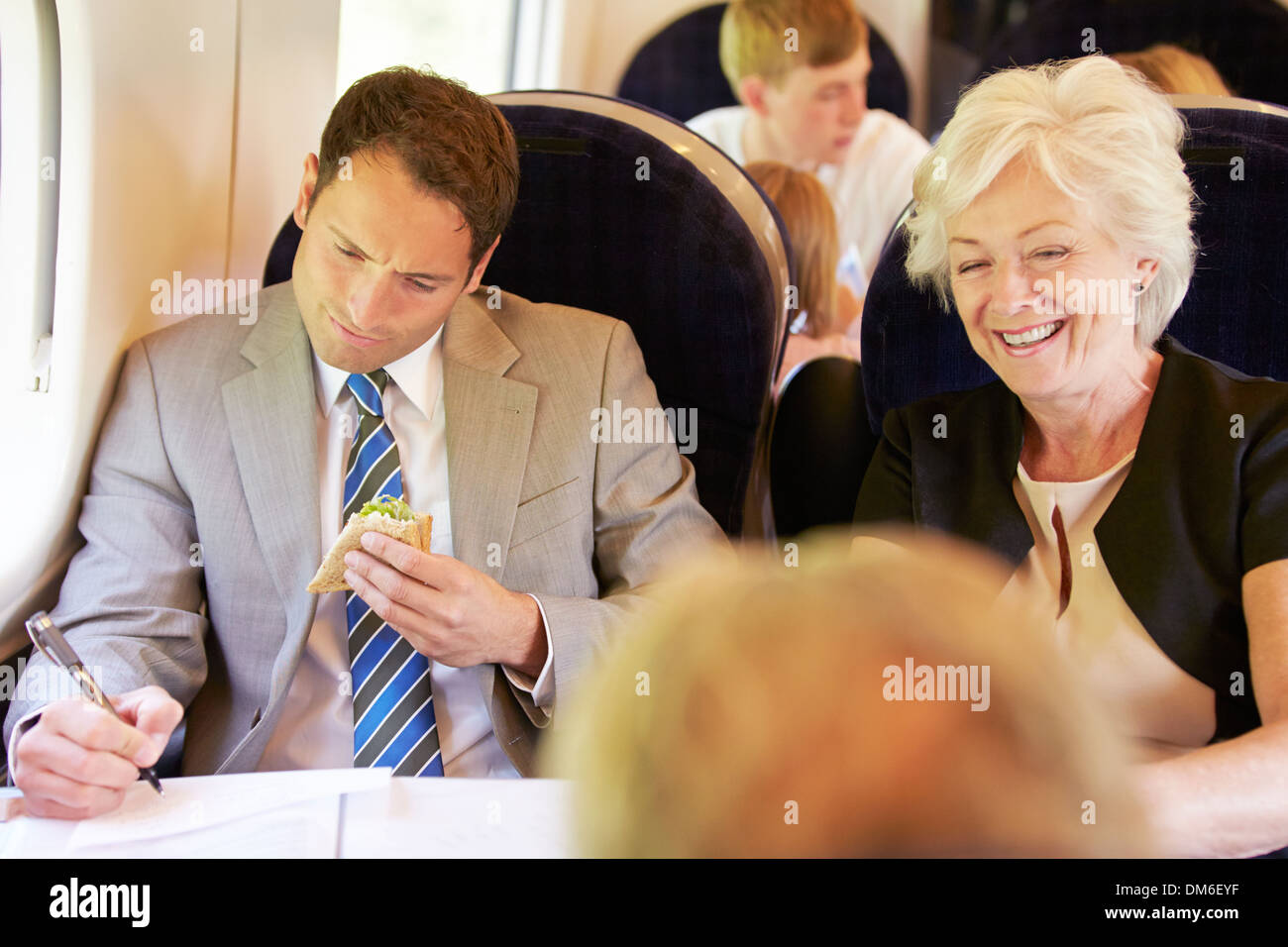 Businessman Eating Sandwich On Train Journey Stock Photo - Alamy