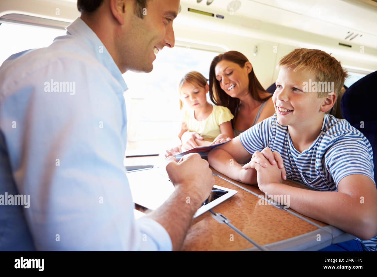 Family Relaxing On Train Journey Stock Photo - Alamy