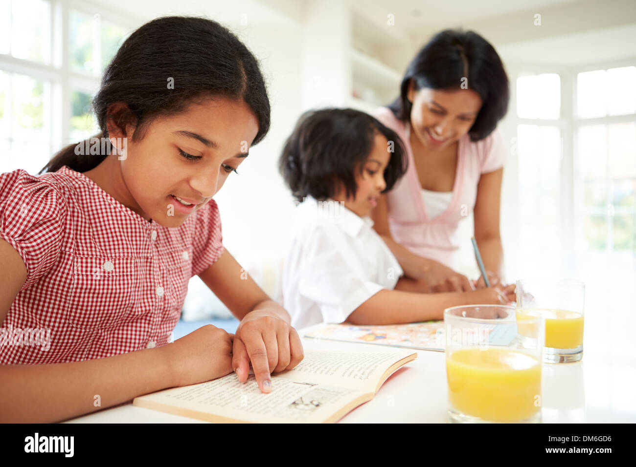 Mother Helping Children With Homework Stock Photo - Alamy
