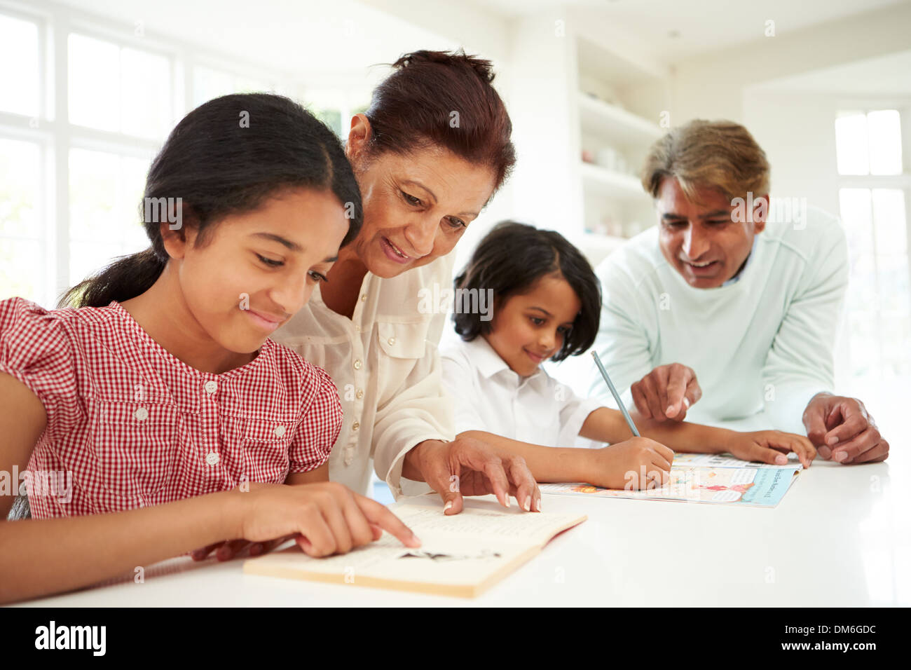 Grandparents Helping Children With Homework Stock Photo - Alamy