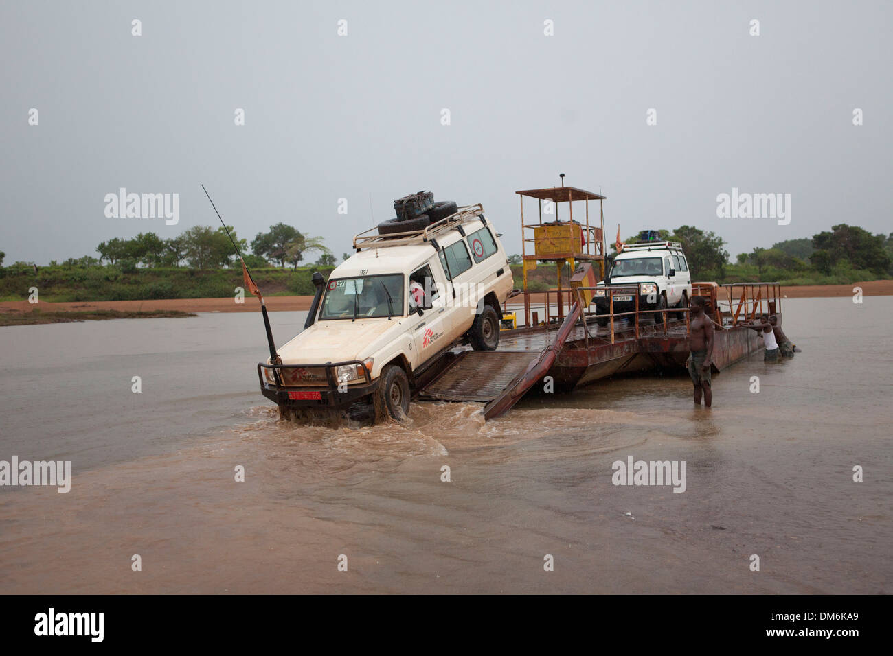 Cars of MSF crossing a river in central african republic Stock Photo ...