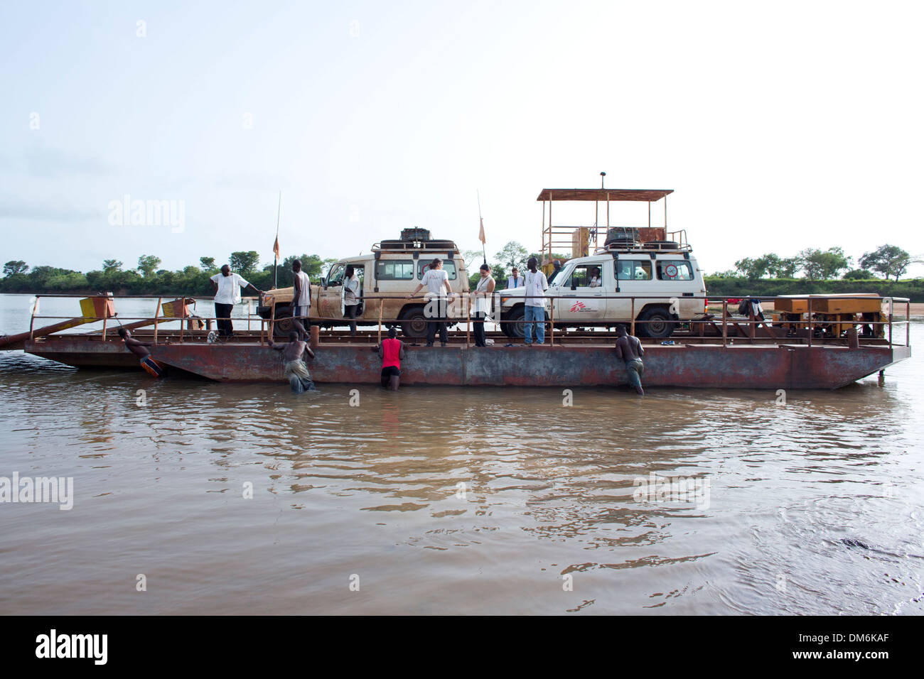 Cars of MSF crossing a river in central african republic Stock Photo ...