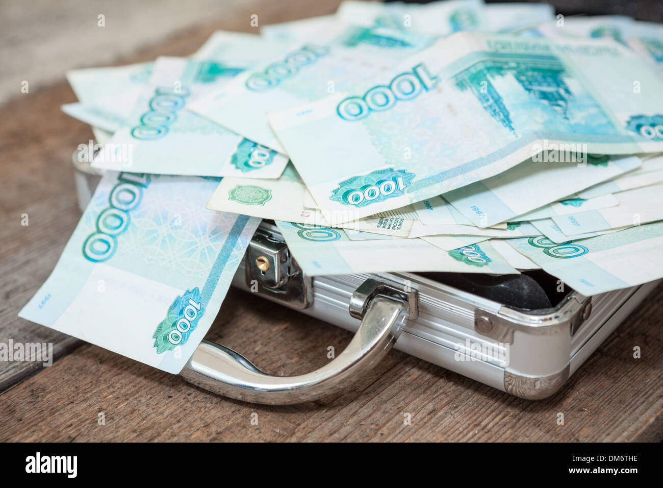 Opened steel case with Russian banknotes inside on wooden floor Stock ...