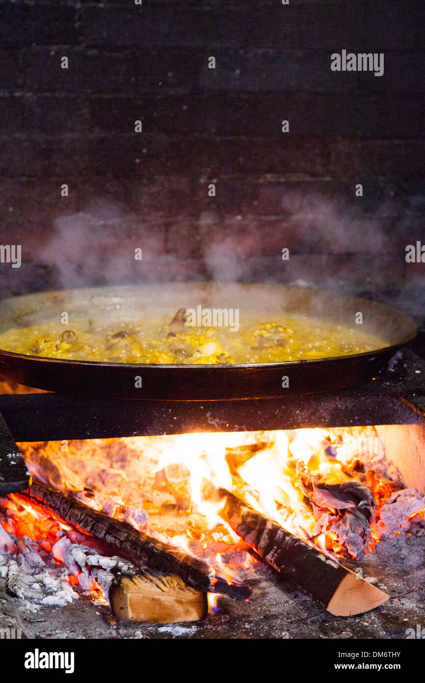 Paella cooking over traditional wood fire, Valencia, Spain Stock Photo ...
