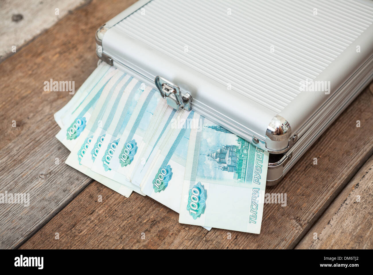 Closed steel case with Russian banknotes inside on wooden floor Stock ...