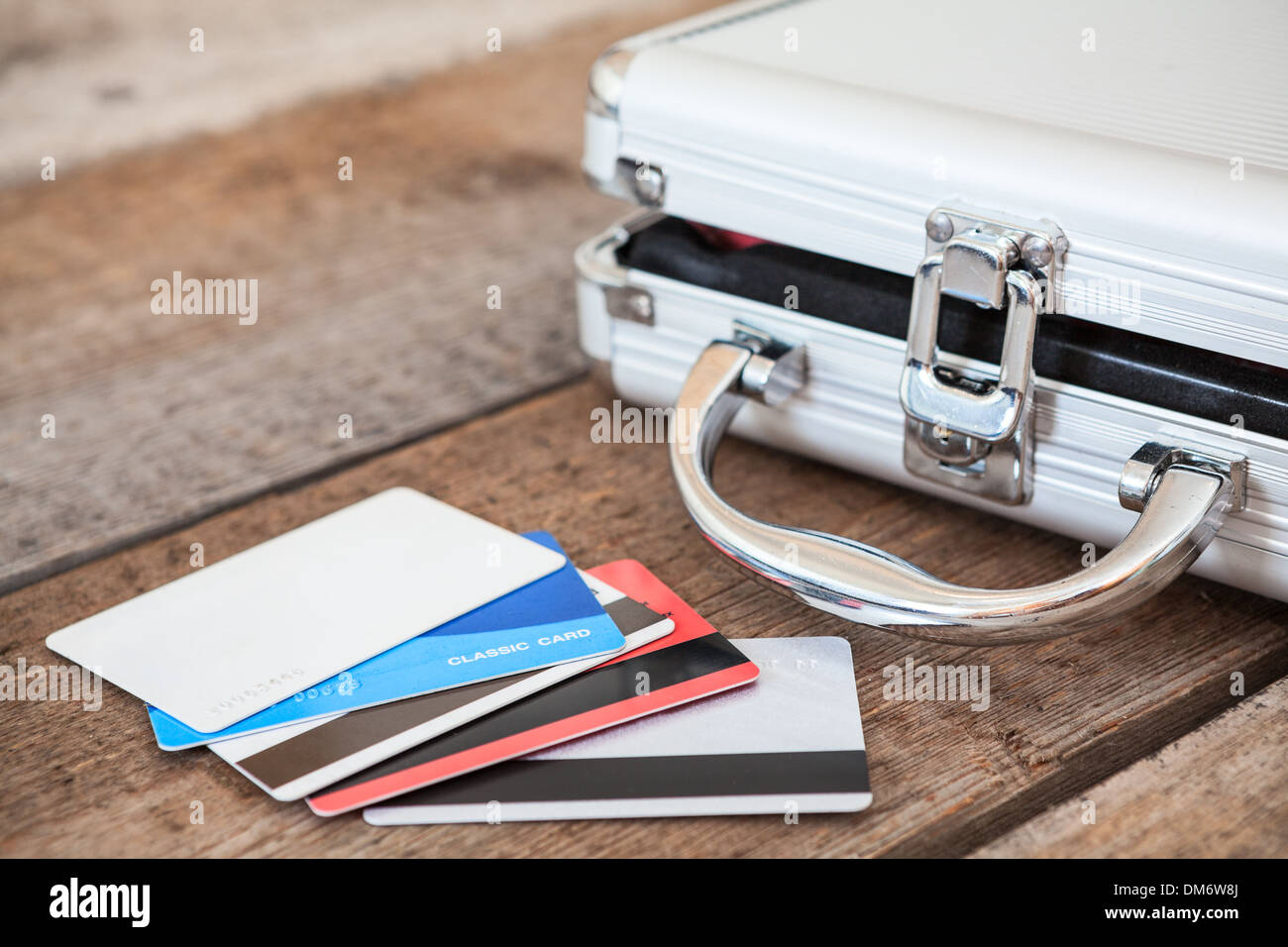 Credit cards and opened steel case laying on wooden floor Stock Photo ...