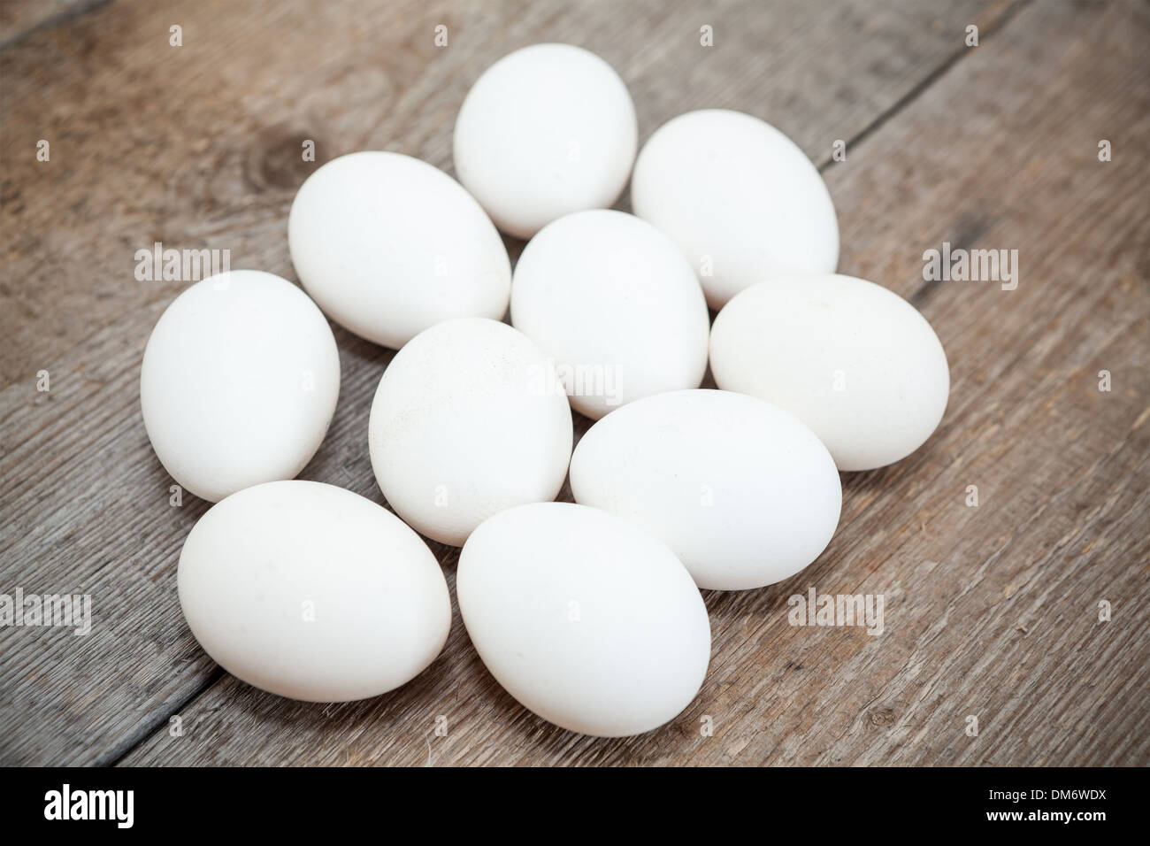 Ten chicken white eggs laying on wooden floor Stock Photo - Alamy