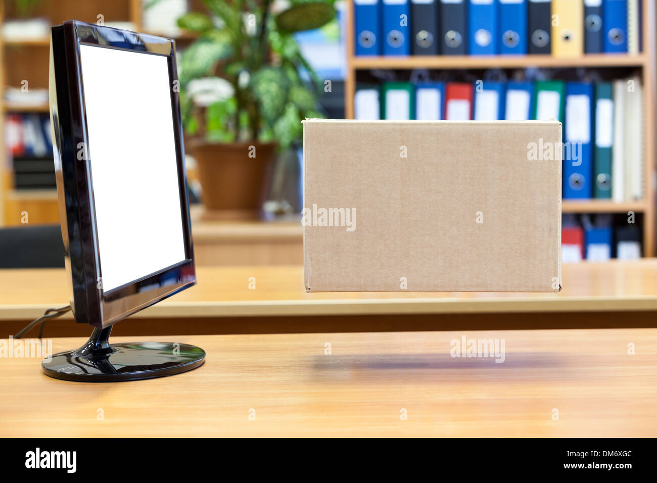 Cardboard box hanging in front of isolated white screen computer ...