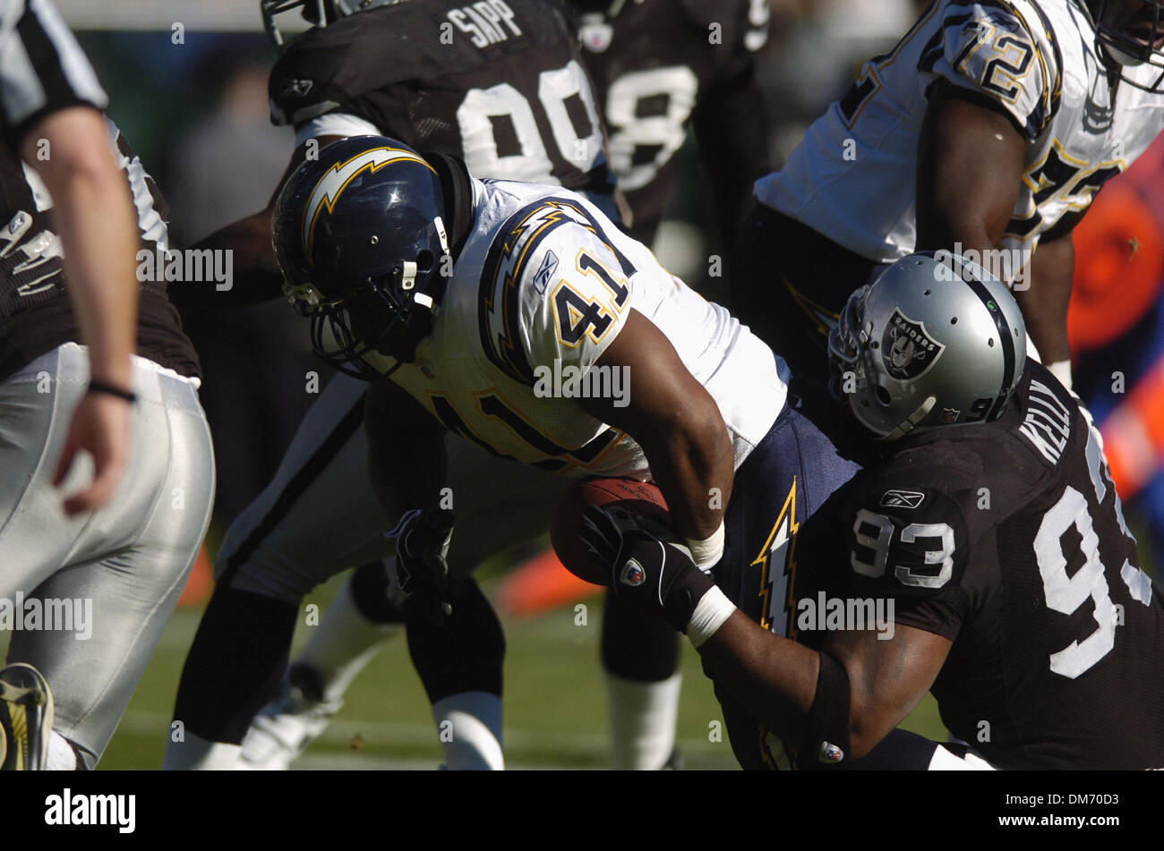 Oakland Raider lineman #93 Tommy Kelly stripes the ball out of Chargers ...