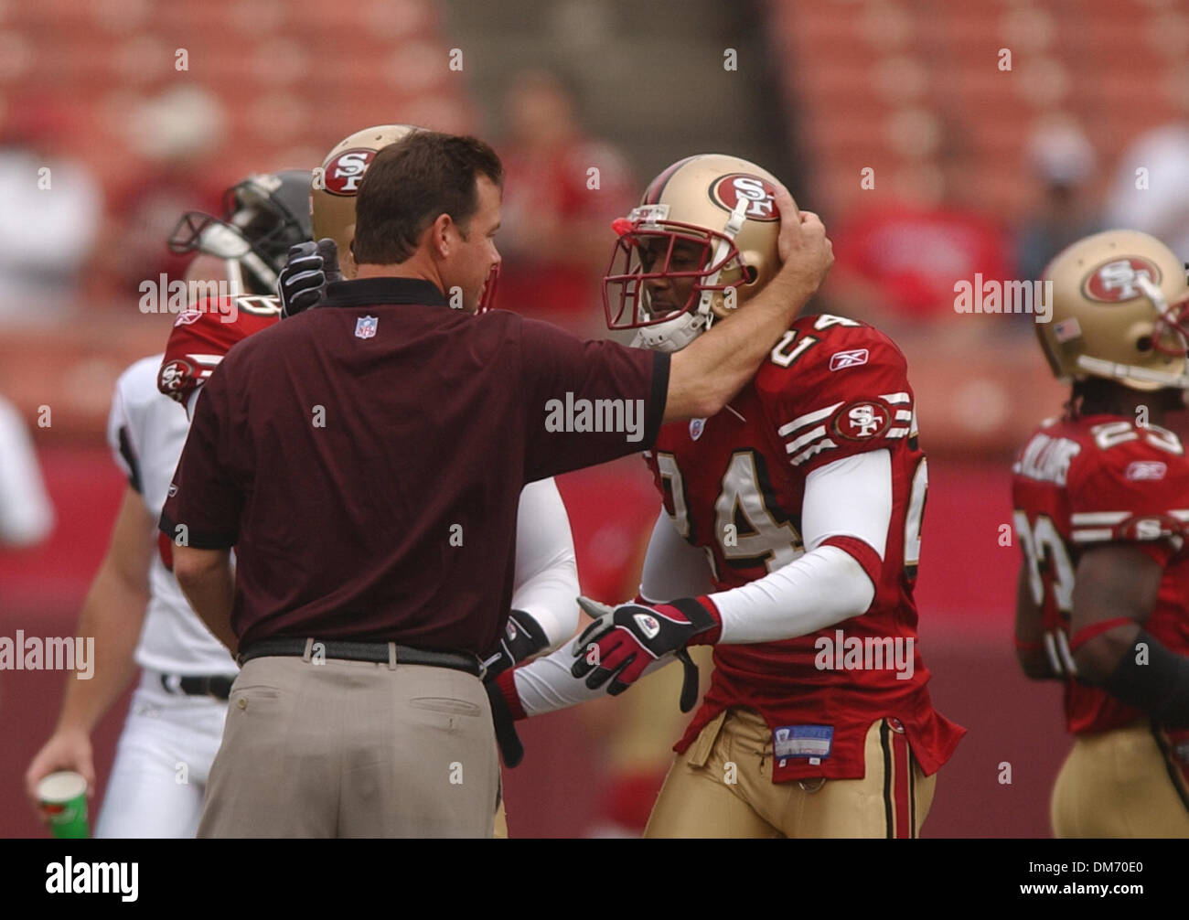 Atlanta Falcon head coach Jim Mora Jr. embraces 49er cornerback Mike ...