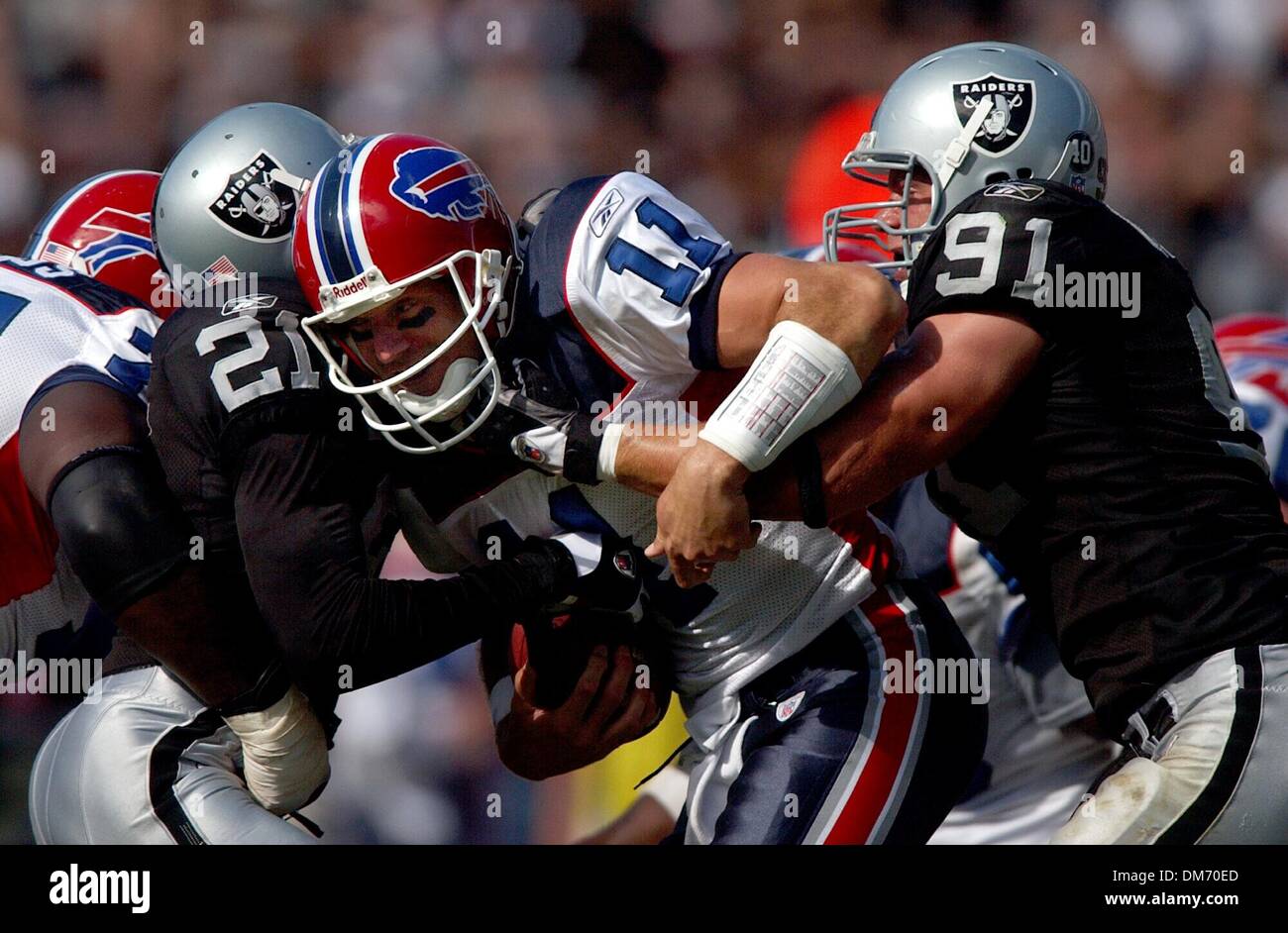 Oakland Raiders defense #21 Nnamdi Asomugha and #91 Tyler Brayton sack ...