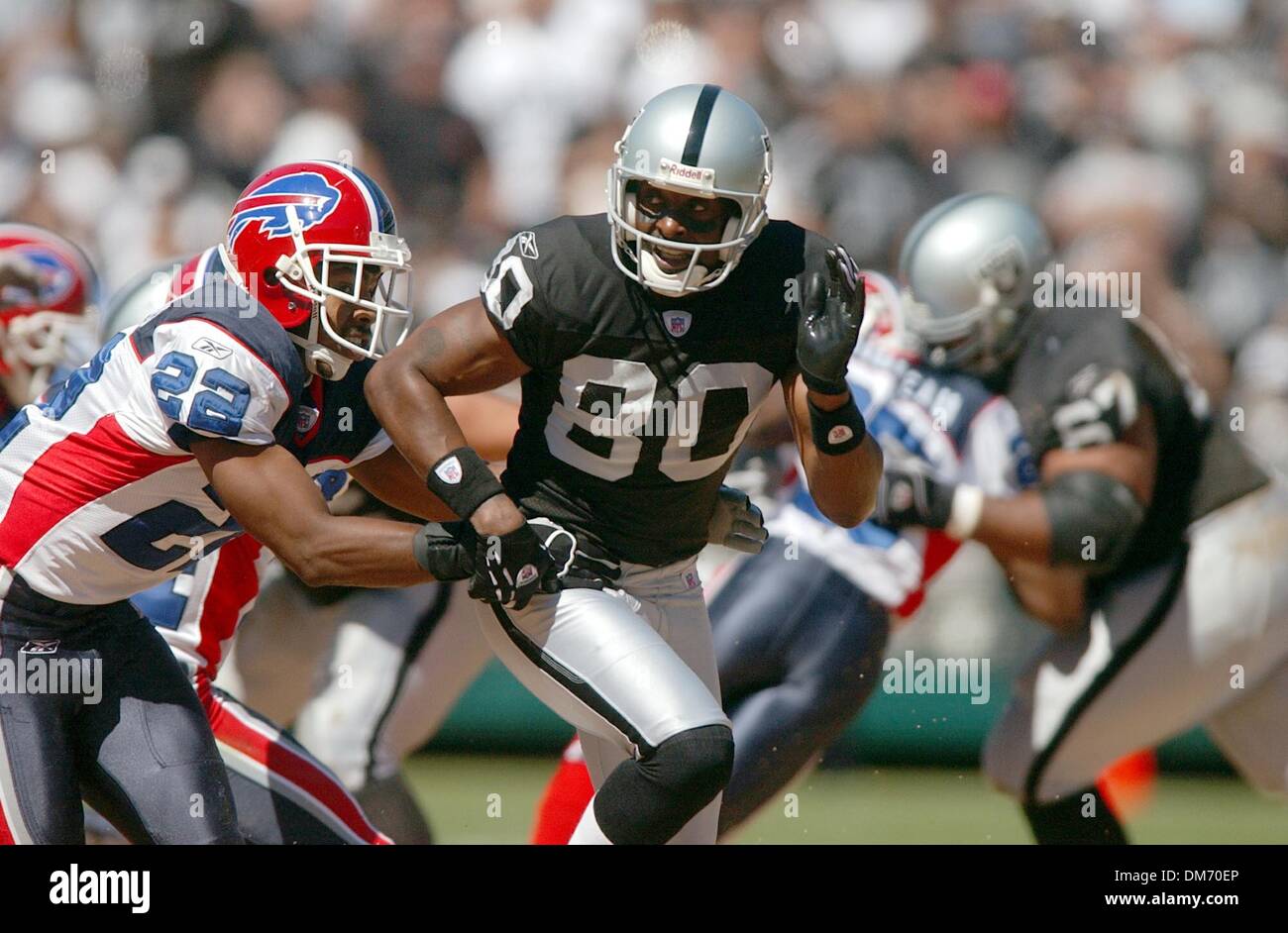 Jerry Rice of the Oakland Raiders is defended by Buffalo Bills ...