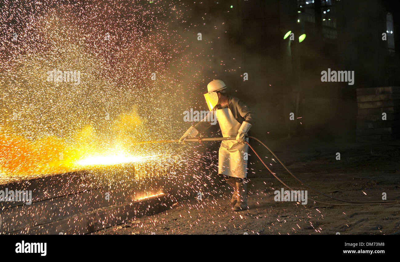 worker using torch cutter to cut through metal shoot in a plant Stock ...