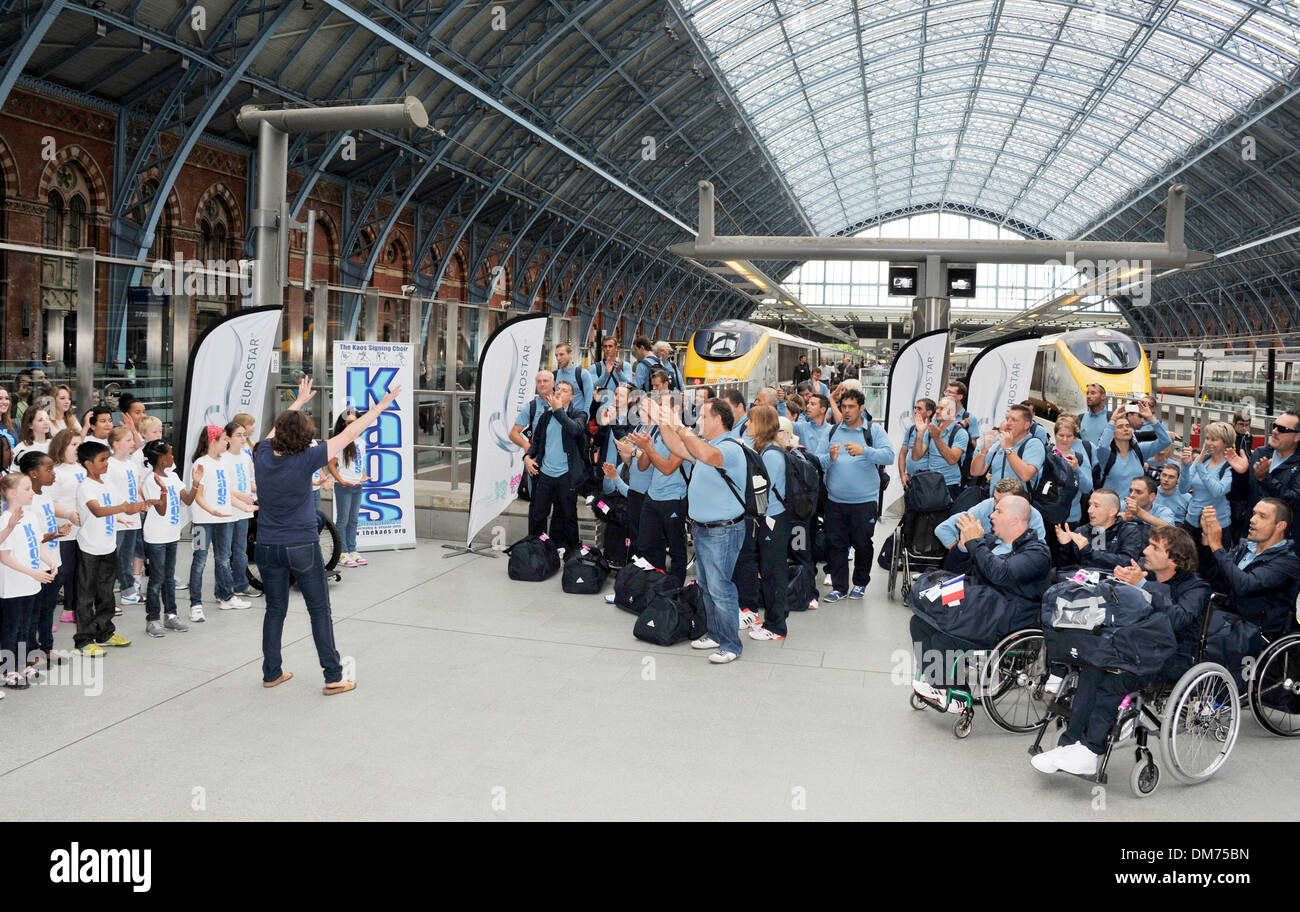 A children's choir sings for the French Paralympic team as they arrive ...