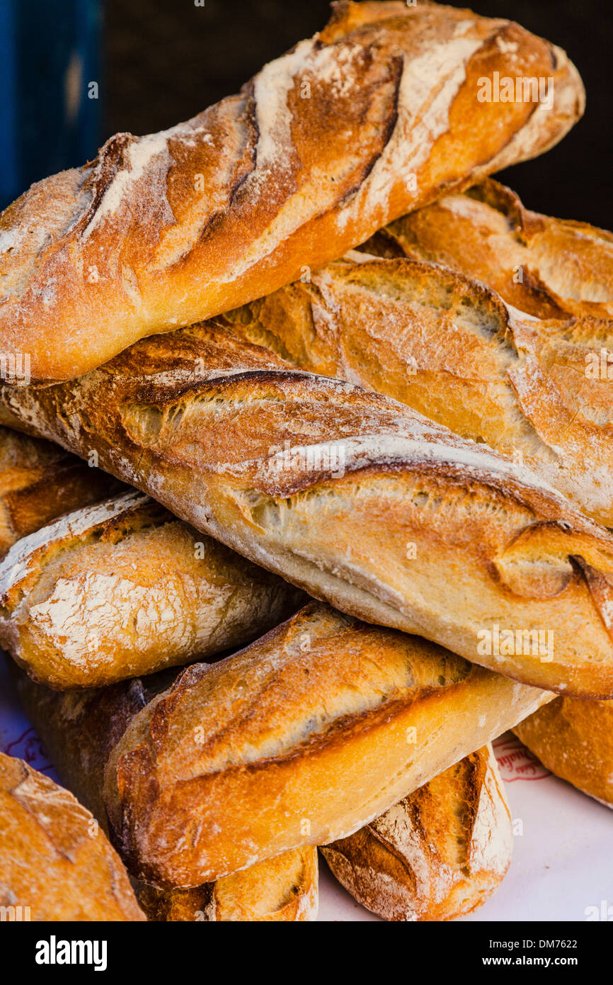 Loaves of freshly baked bread stacked on top of each other on market ...