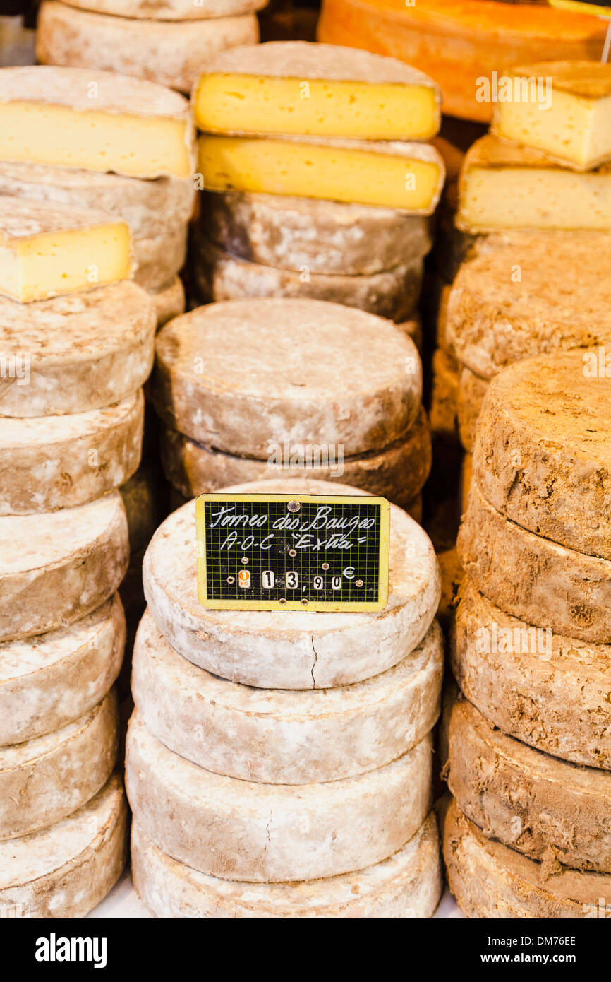 Rounds of Tome (Tomme) cheese stacked on top of each other in the ...