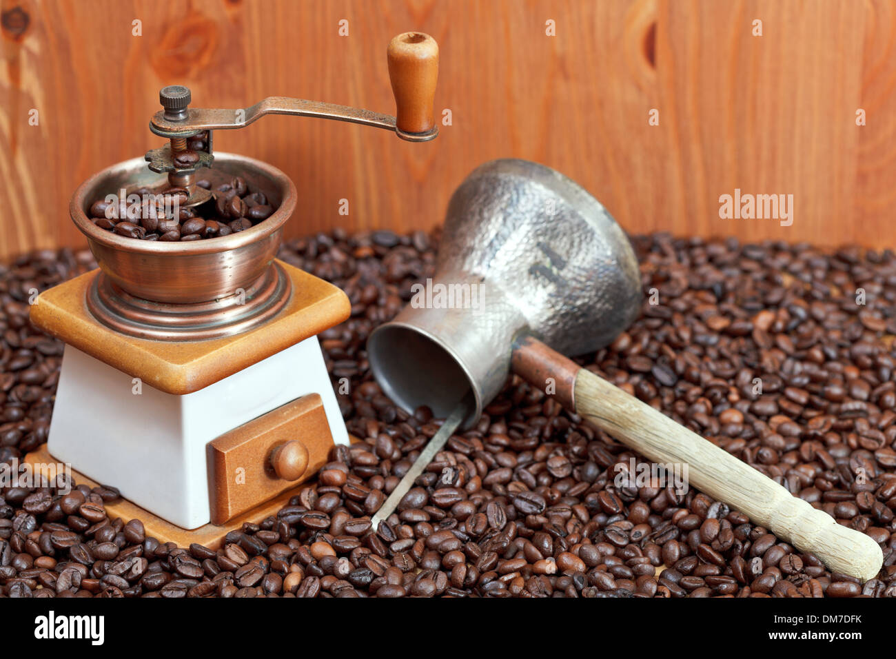 retro manual coffee grinder and copper pot on many roasted coffee beans ...