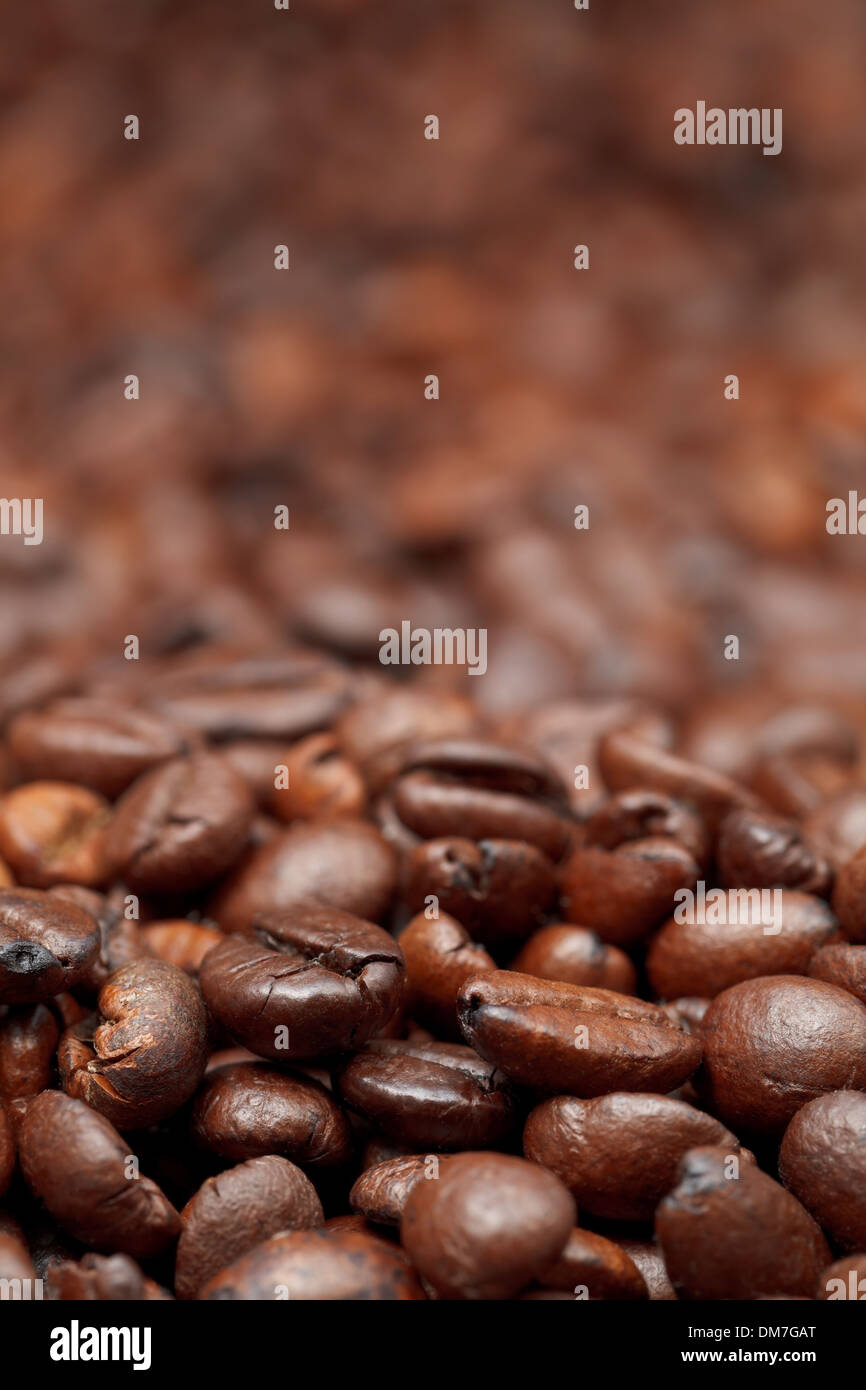 dark roasted coffee beans close up background Stock Photo - Alamy