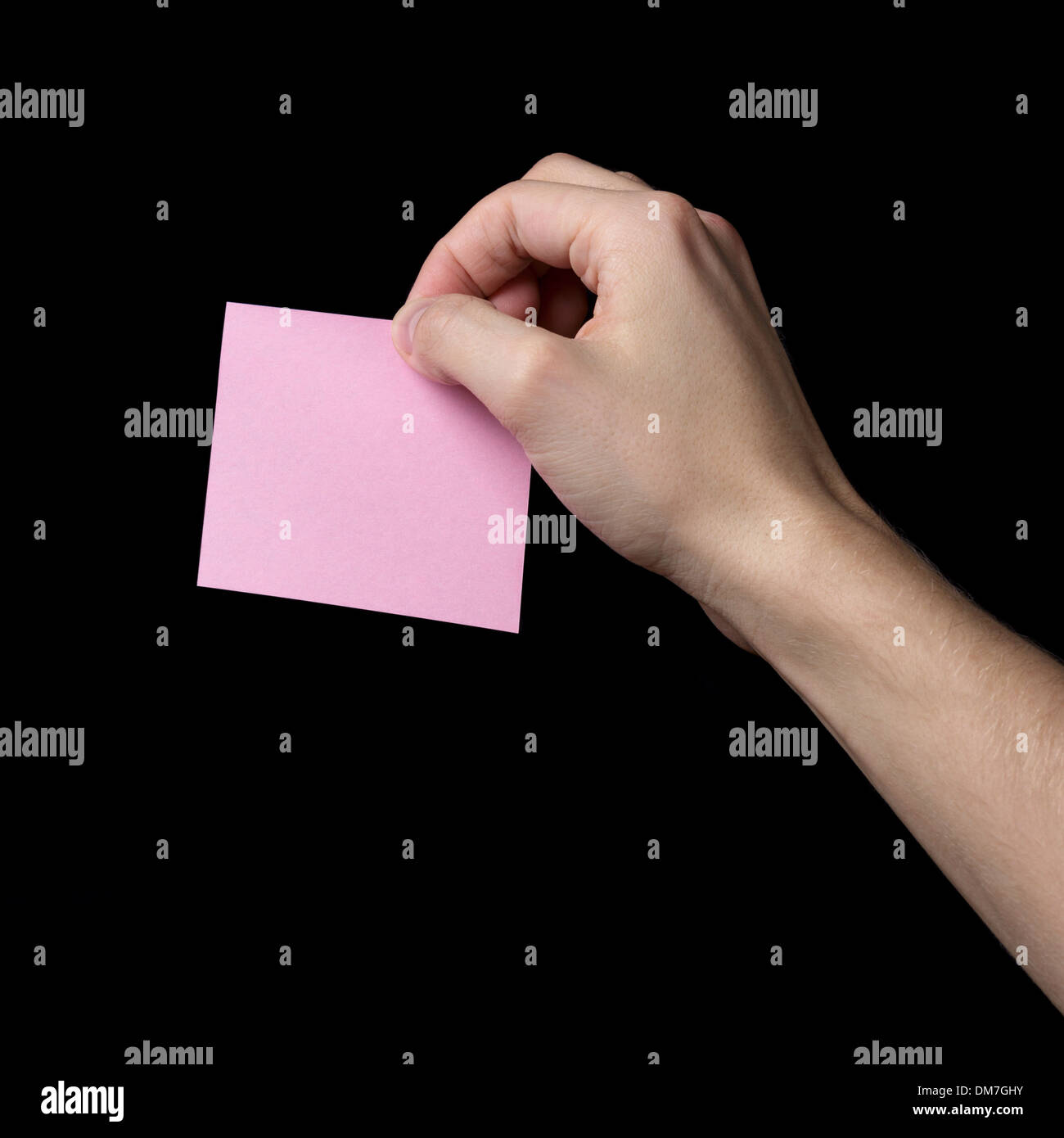 adult man hand holding sticky note, isolated on black Stock Photo - Alamy