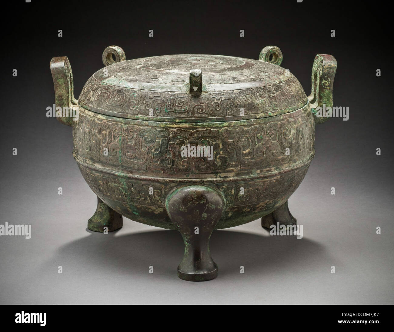 This lidded ritual food cauldron (Ding) features interlaced dragons, a ...
