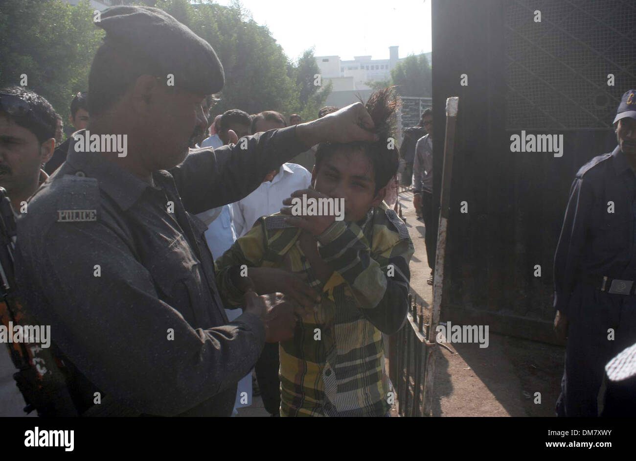 Karachi, Pakistan. 12th Dec, 2013. Police official arresting pocket ...