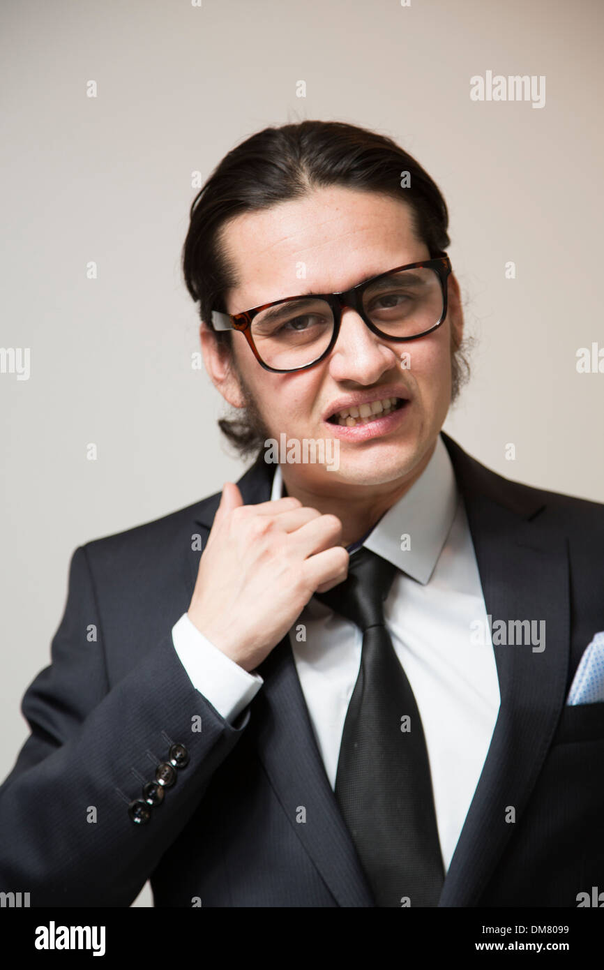 young latino business man getting a bit nervous Stock Photo - Alamy