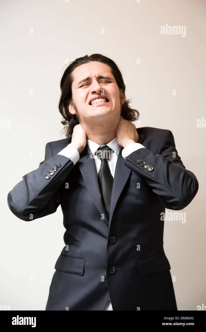 young latino business man getting extremely frustrated Stock Photo - Alamy