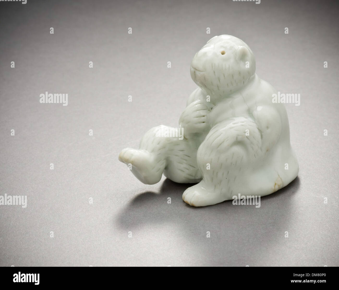 This okimono sculpture depicts a monkey dressed in traditional costume ...