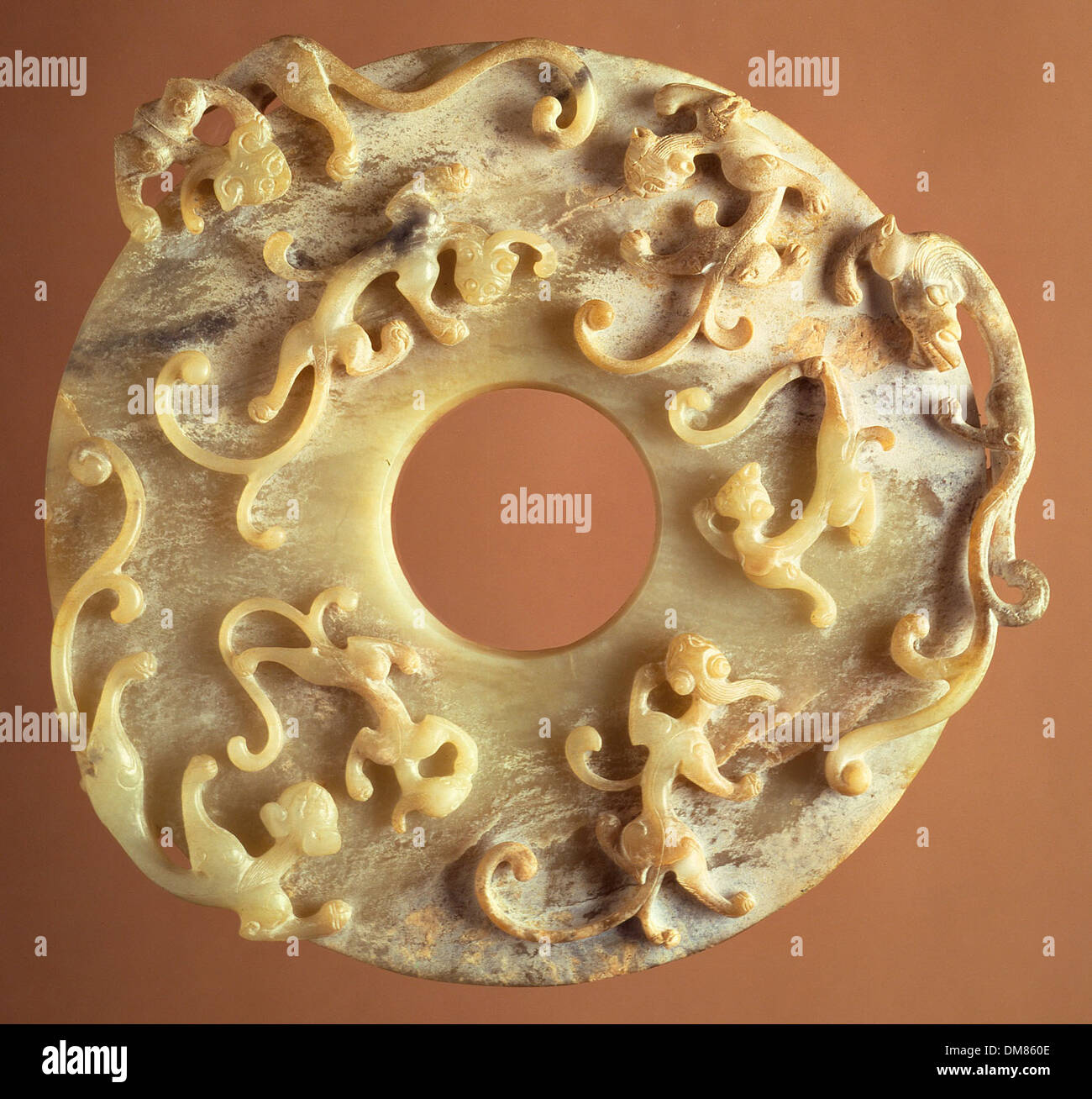 This perforated disk, or Bi, features a dragon design, symbolizing ...