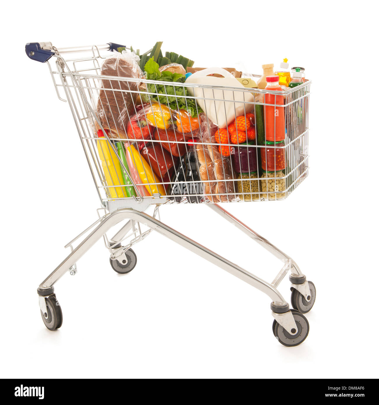 Shopping cart full with dairy grocery products isolated over white ...