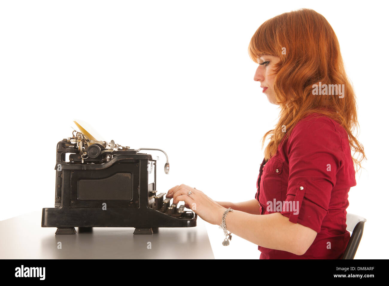 Woman is typing on black vintage typewriter isolated over white ...