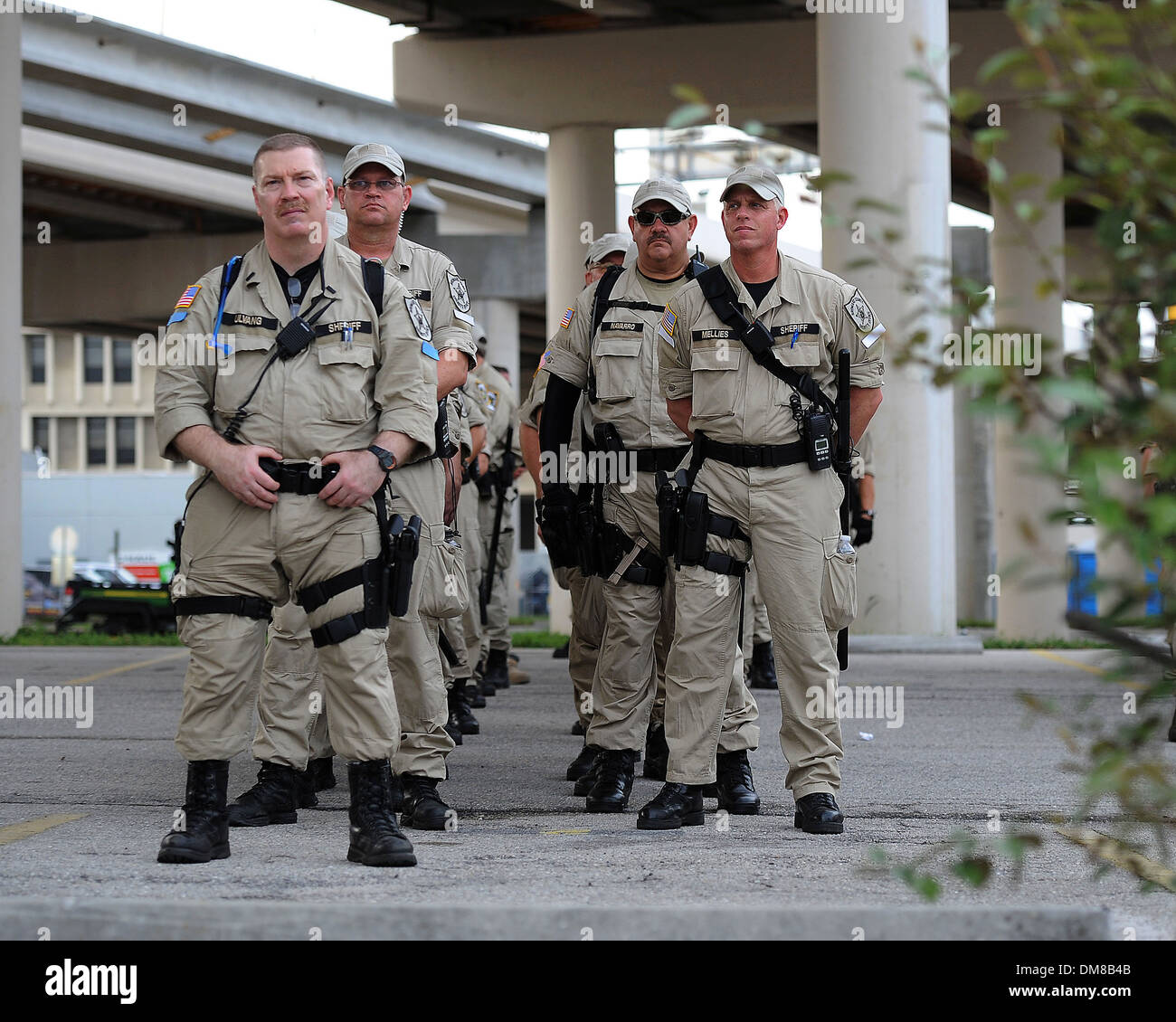 Riot police watch protestors march in front of St Pete Times Forum ...
