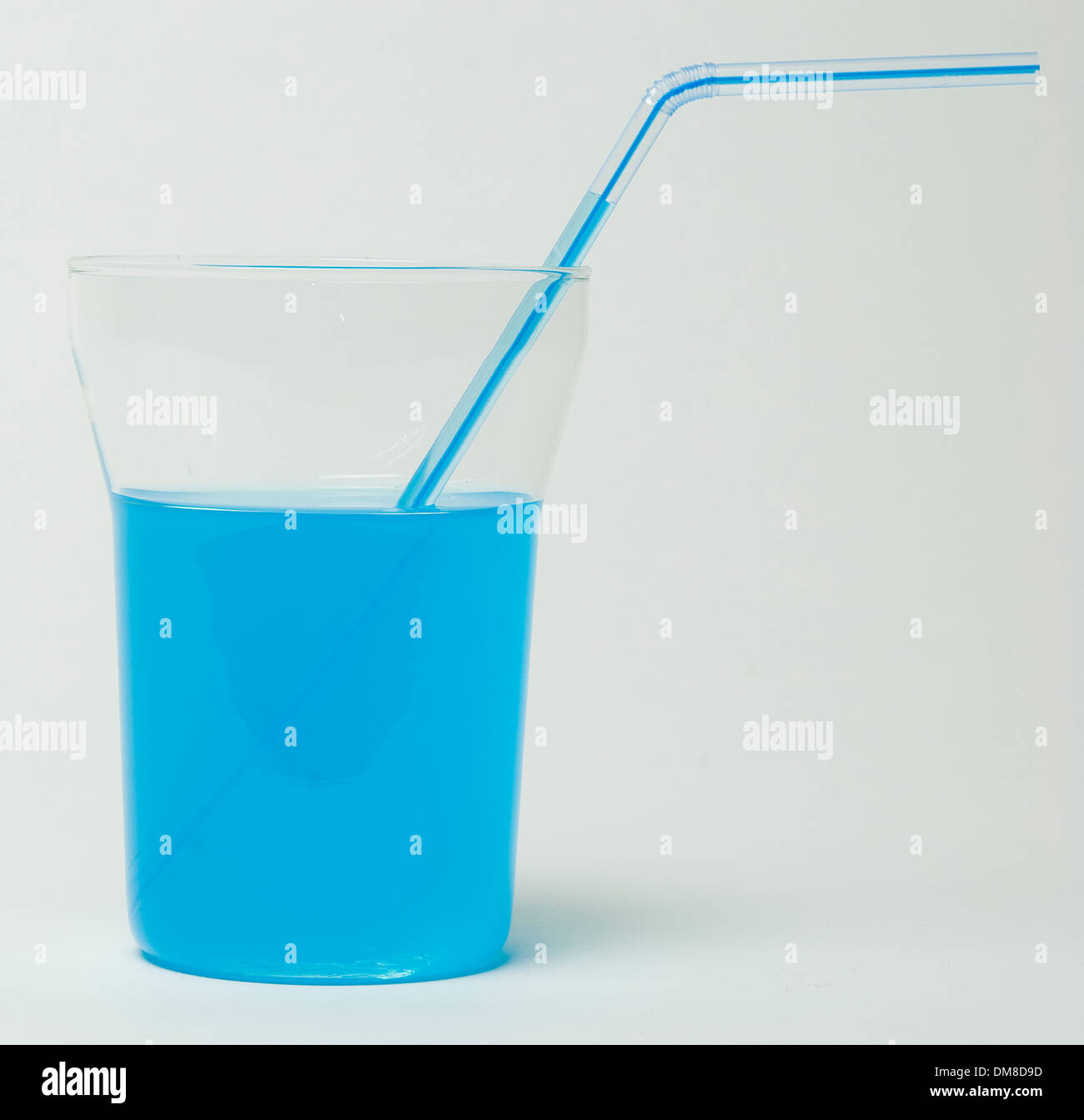 Glass with a straw and blue liquid in it on a white background Stock ...