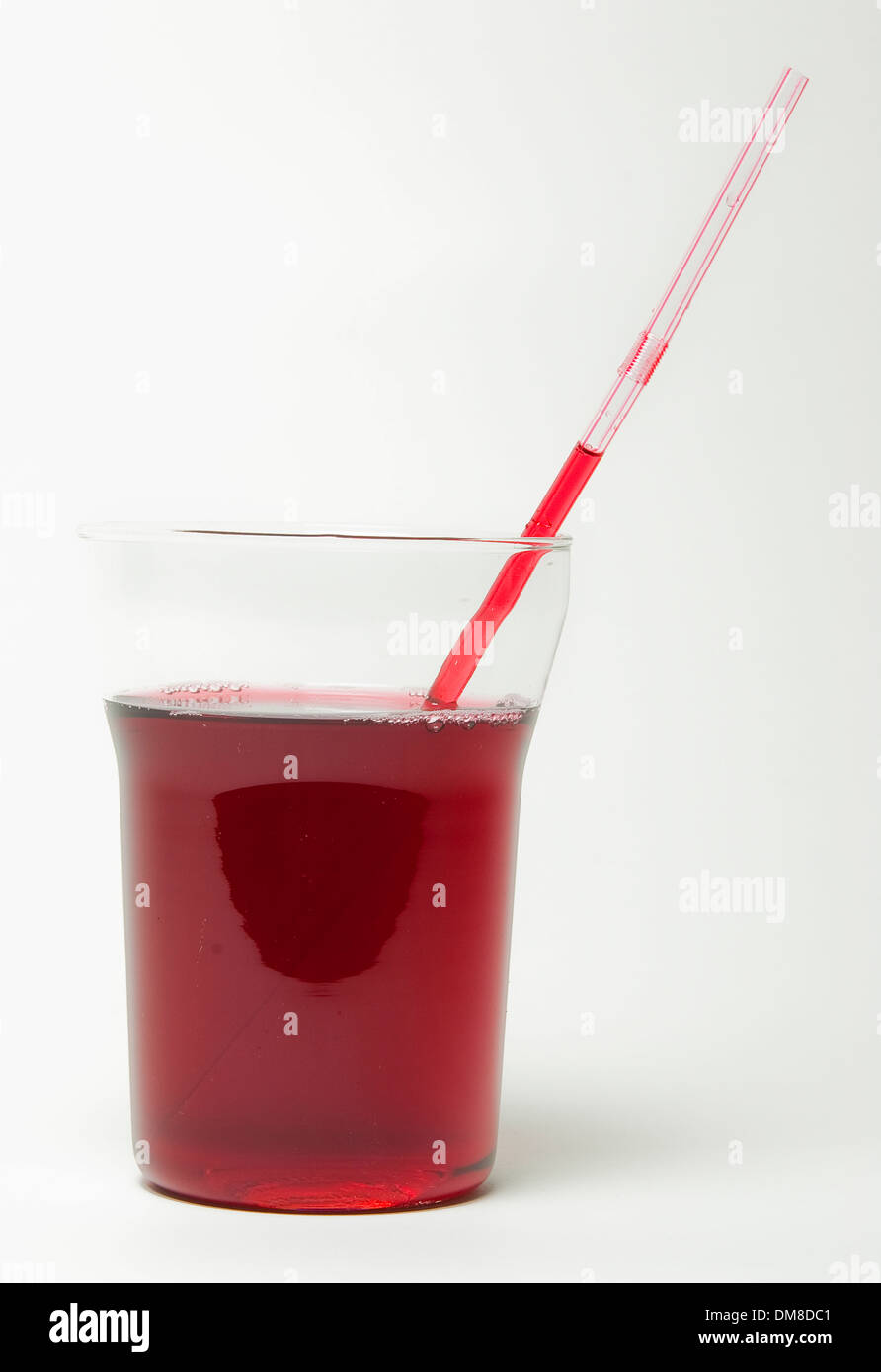 Glass with a straw and red liquid in it on a white background Stock ...