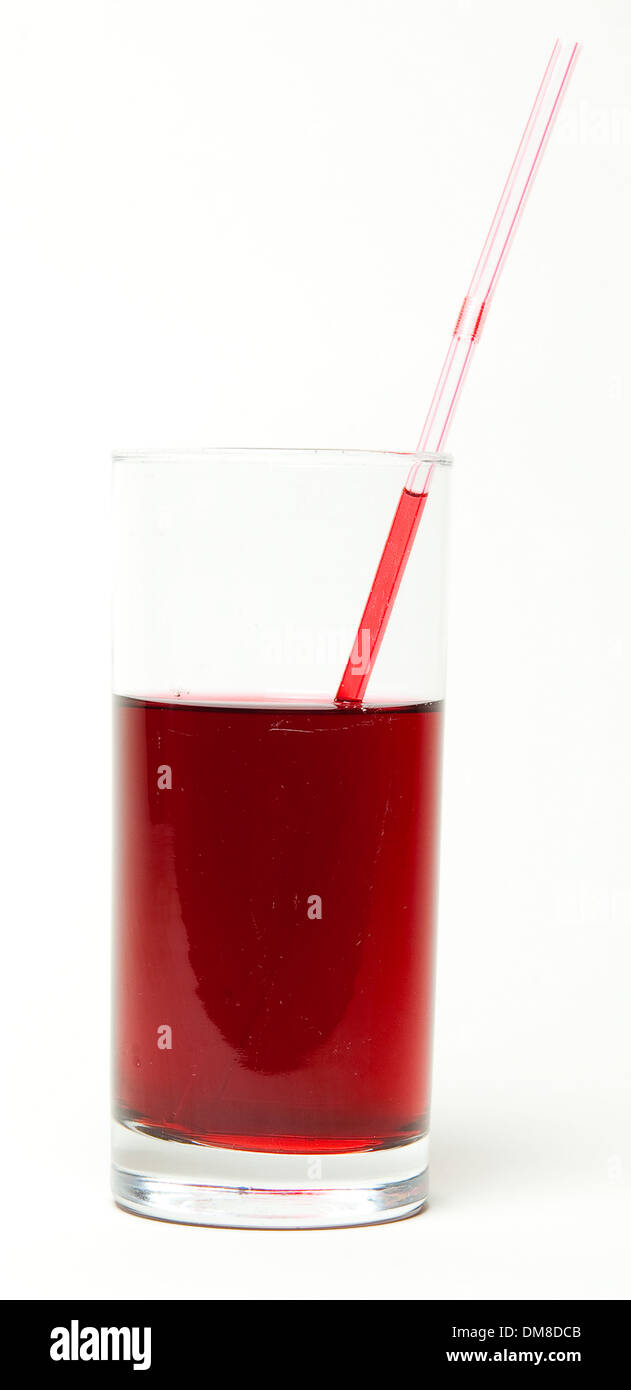 Glass with a straw and red liquid in it on a white background Stock ...