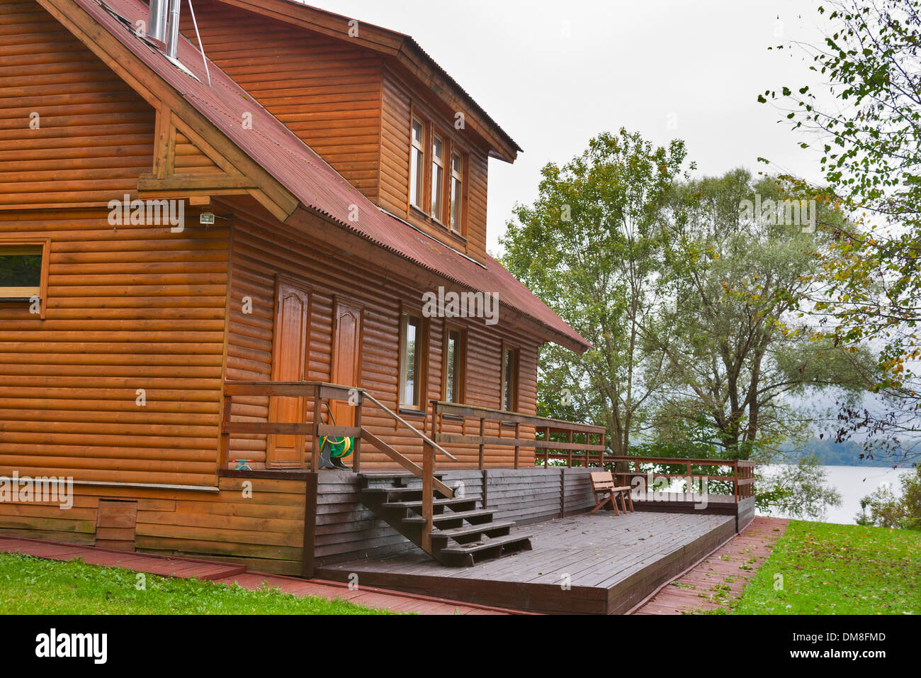 country wooden house in the forest close to lake Stock Photo - Alamy